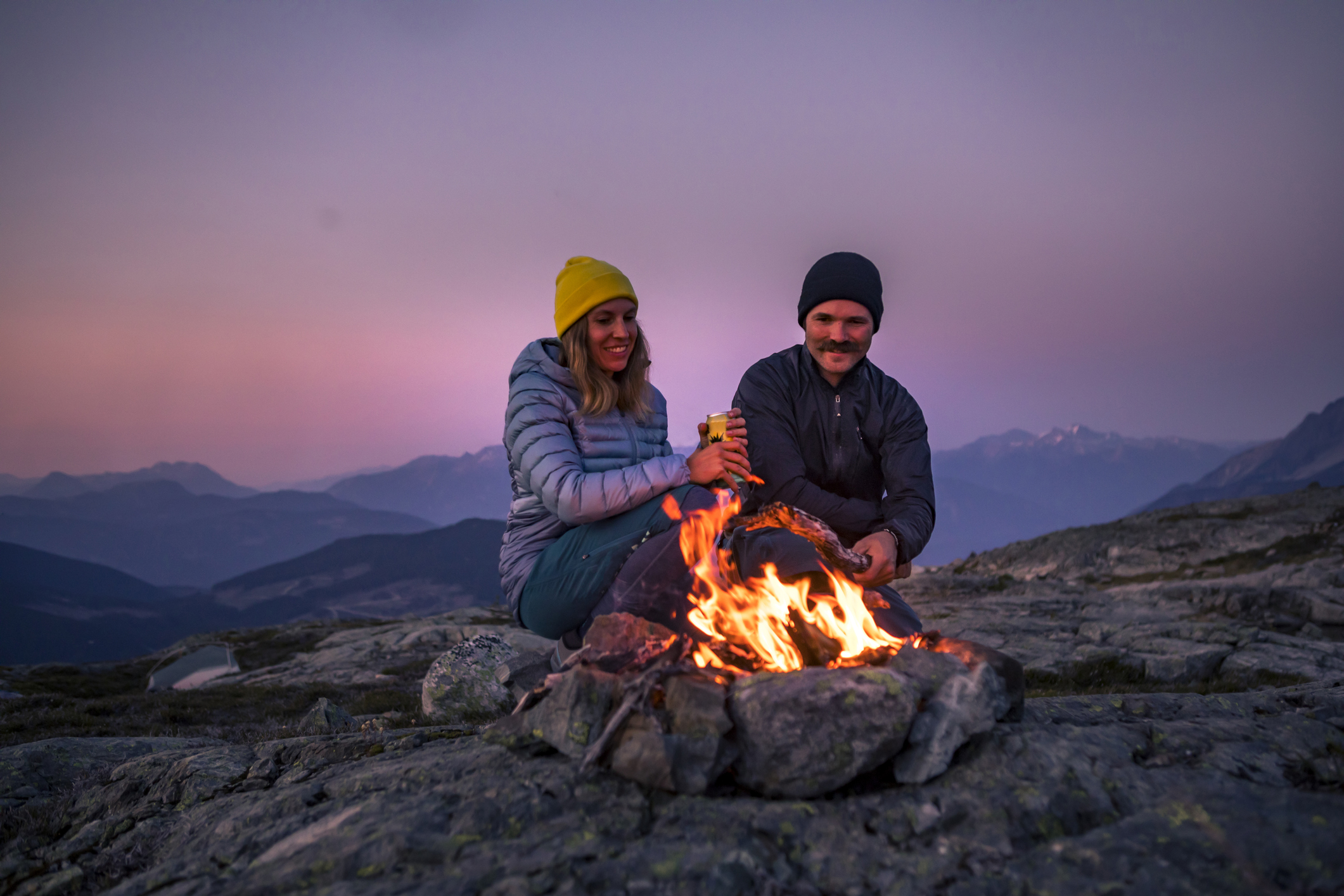 Couple making bonfire on top of mountain at dusk. - RV Lifestyle News ...